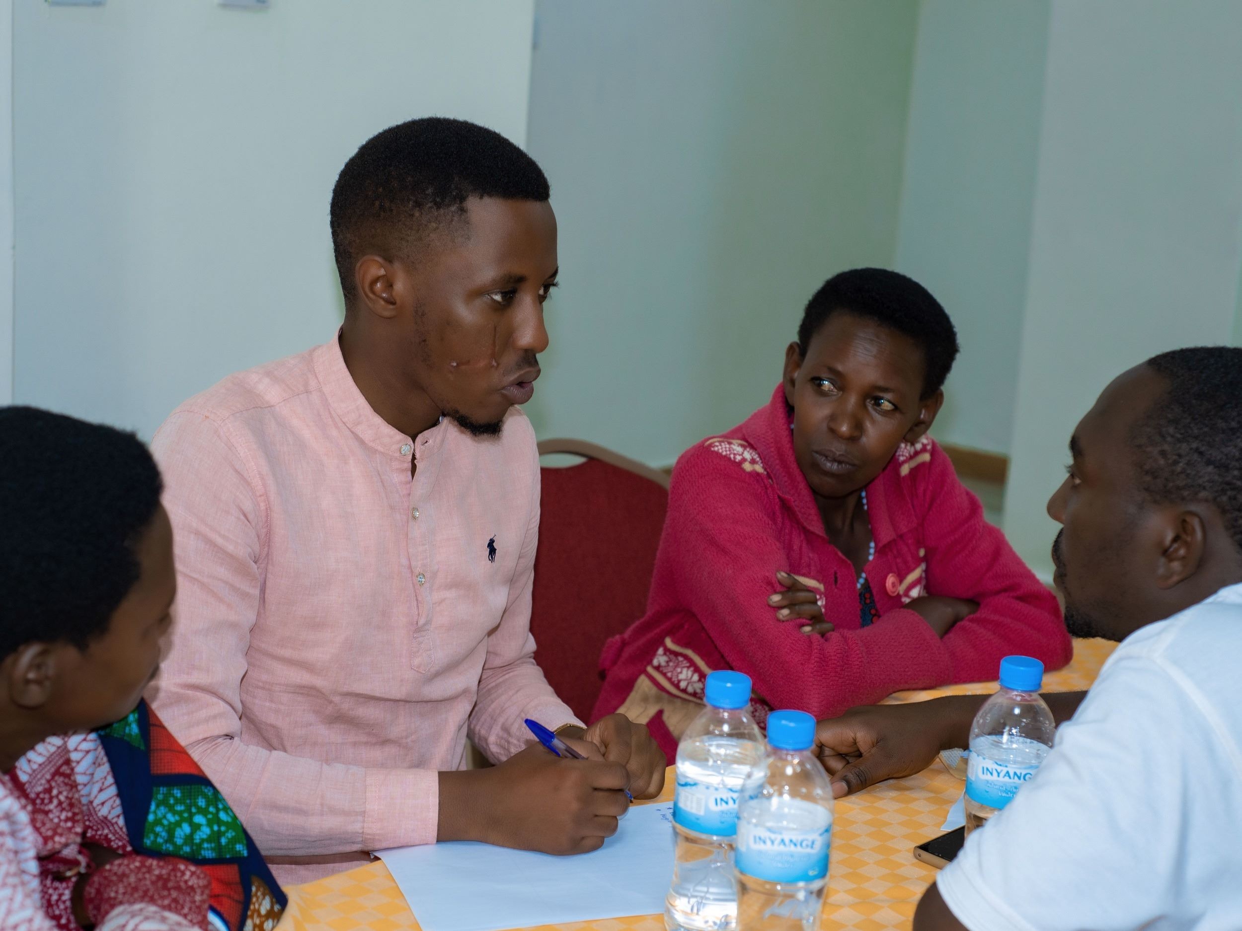 Hope of Family's staff members actively engaged in a group discussion on tasks given.